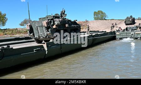 An M1126 Stryker Combat Vehicle crosses an improved ribbon bridge ...