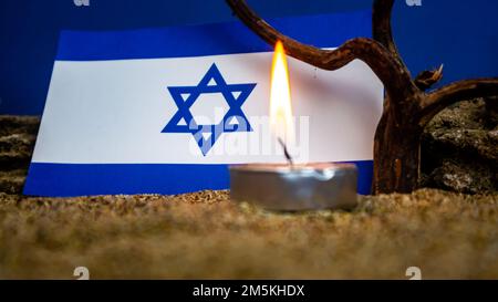 Israeli flag and burning candles in front of it, Holocaust memory day ...