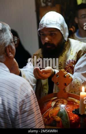Coptic priests by the Coptic chapel in the back side of the Aedicule inside the church of the ...