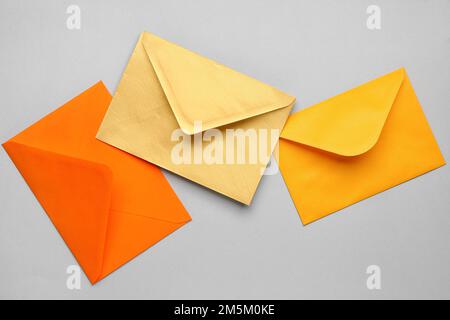 Colorful paper envelopes on light blue background, flat lay. Space for ...