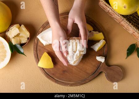 Top view of fresh peeled pomelo on bright wooden table background for ...
