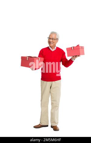Shed older men with gift box Stock Photo - Alamy