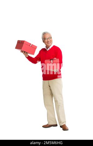 Shed older men with gift box Stock Photo - Alamy