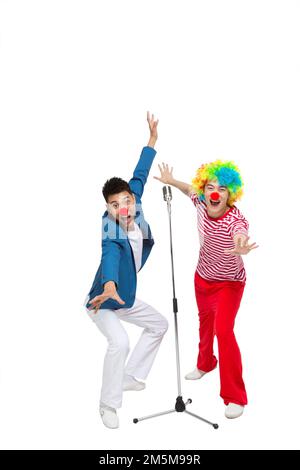 Funny clown with a microphone singing karaoke isolated on white ...