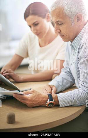 Two coworkers working together analyzing the charts in office Stock ...