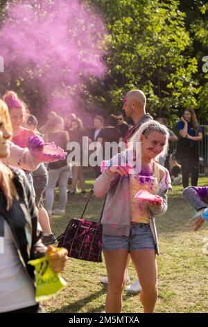 A group of a young people throwing colorful holi powder Stock Photo - Alamy