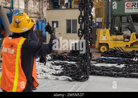 Shop 72 Riggers use cranes to lift anchor chains currently being worked ...