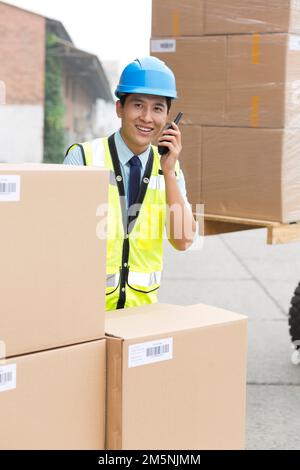Logistics warehouse management personnel with interphone Stock Photo ...