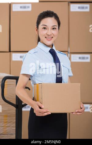 Logistics warehouse staff holding the carton Stock Photo - Alamy