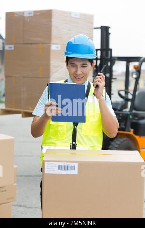 Logistics warehouse management personnel with interphone Stock Photo ...