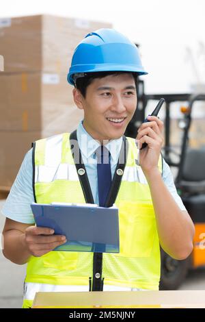 Logistics warehouse management personnel with interphone Stock Photo ...