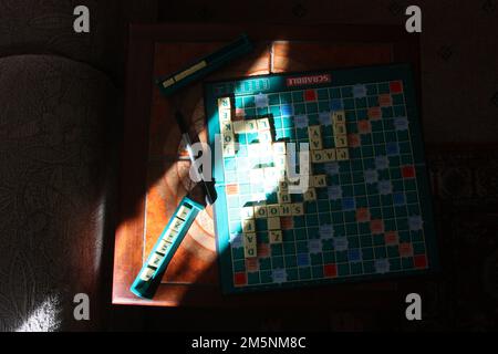 Overhead of a scrabble board game in play in dramatic light, UK Stock ...