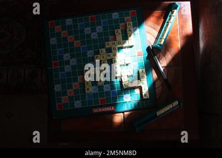 Overhead of a scrabble board game in play in dramatic light, UK Stock ...