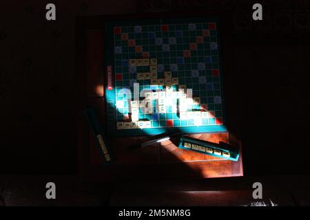 Overhead of a scrabble board game in play in dramatic light, UK Stock ...