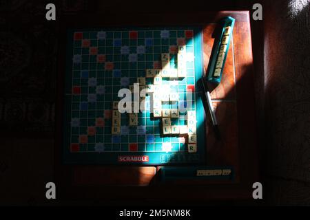Overhead of a scrabble board game in play in dramatic light, UK Stock ...