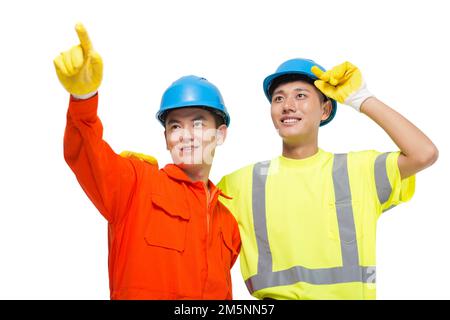 Two workers stand on a raised scissor lift beside a glass and stone ...