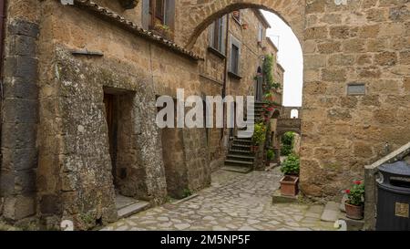 Old tufa buildings decorated with flowers in the hilltop village of ...