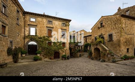 Old tufa buildings decorated with flowers in the hilltop village of ...