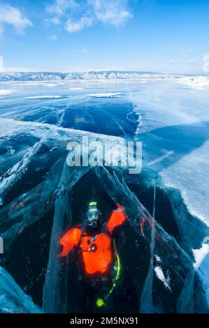 Scuba diver under ice, Lake Baikal, Pribaikalsky National Park, Irkutsk ...