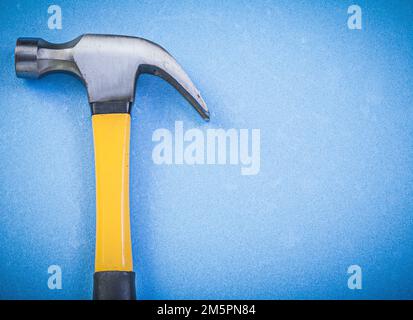Horizontal view of claw hammer and metal flat chisels in wooden ...