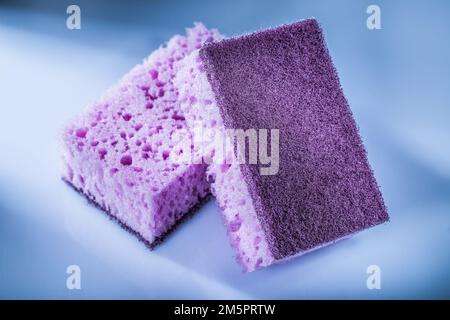 New violet kitchen sponges on white surface Stock Photo - Alamy