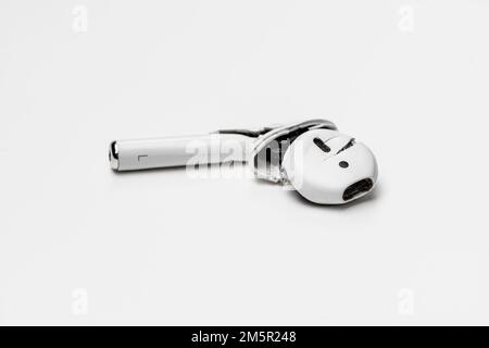 A broken Apple Airpod (wireless headphones) sits lifeless and non ...