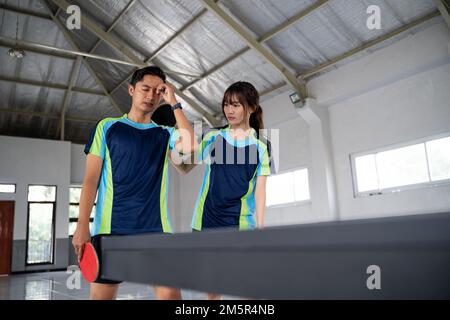 Asian male and female ping pong players get frustrated Stock Photo - Alamy