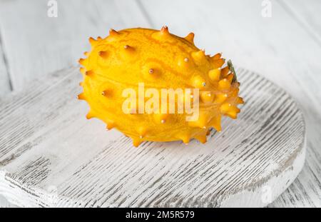 African horned cucumber on the wooden table Stock Photo - Alamy