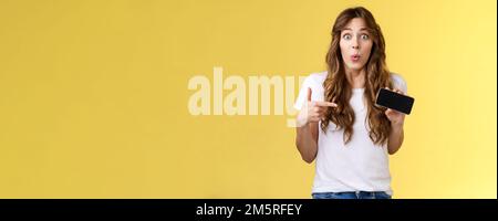 Surprised enthsuastic intrigued cute curly-haired caucasian girl ...