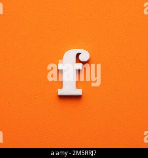 j white lowercase letter - Background in orange foamy Stock Photo - Alamy