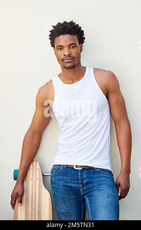 Young adult skating outdoors - Stylish skater boy training in a nNew ...