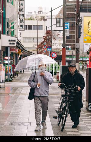 People on the streets of Asakusa during a rainy day Stock Photo - Alamy