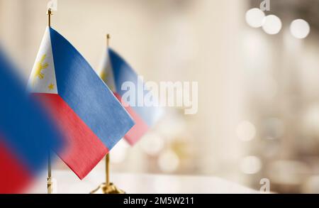 Small flags of the Philippines on an abstract blurry background Stock ...