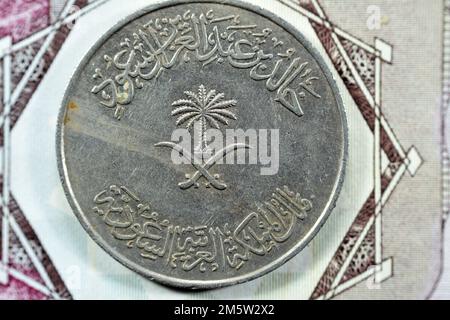 Crossed swords and palm tree at center of obverse side of old Saudi ...