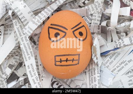 egg face angry on newspapers recycle Stock Photo - Alamy