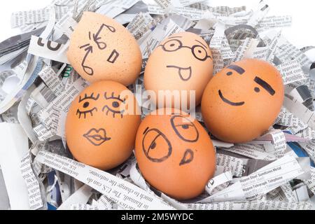 egg face on newspapers recycle Stock Photo - Alamy