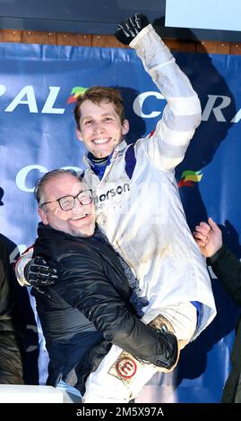 Ged Mason lifts jockey Harry Skelton after winning the Ryanair Steeple ...