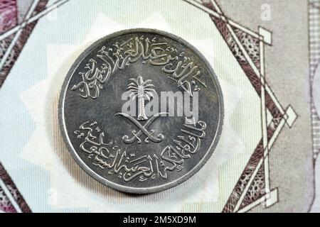Crossed swords and palm tree at center of obverse side of old Saudi ...
