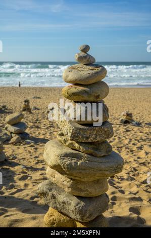 Pyramid from stack balanced stones on sandy beach in sunset, Atlantic ...