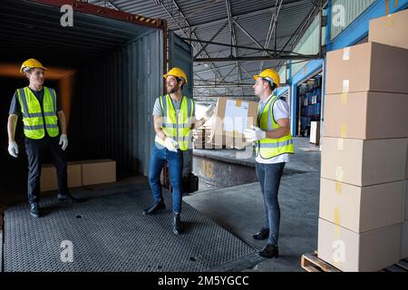 Worker carry carton box taken from 40 feet steel container on the ...