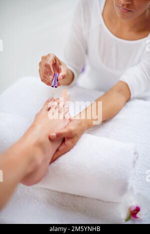 Getting a pedicure. Closeup shot of a woman getting a pedicure in a ...