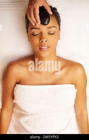 Life is now complete. a young woman getting a massage at the spa Stock ...