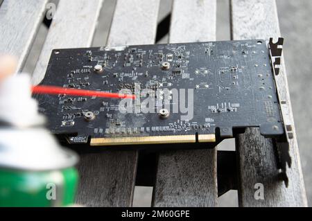 Technician view using spray to clean graphics card Stock Photo - Alamy