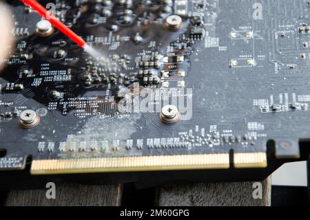 Technician view using spray to clean graphics card Stock Photo - Alamy