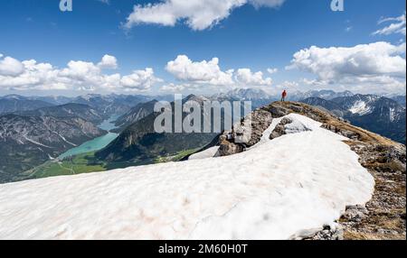 Hikers at the summit of Thaneller, view of mountains with Plansee and ...