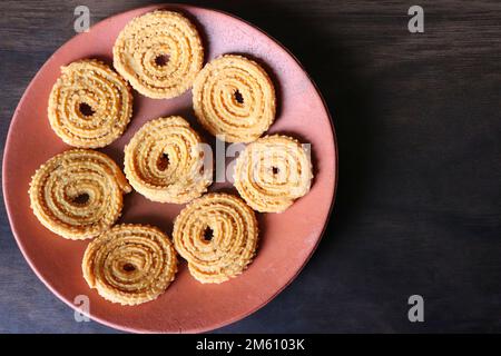 Close-up of Murukku/Indian snack in an earthenware/Terracotta plate ...