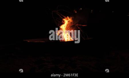 Campfire on snow in the night Stock Photo - Alamy