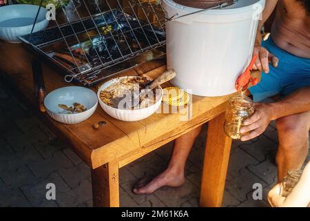 Getting honey from honeycomb. Storing honey in a bottle Stock Photo - Alamy