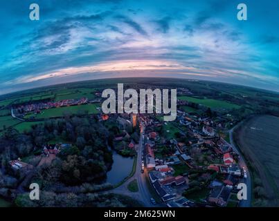 An aerial view at sunrise of the village of Haughley in Suffolk, UK ...