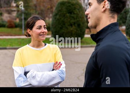Female athletes communicate during break between workouts, gym climbing ...